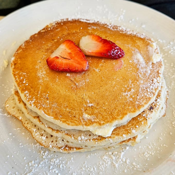 Pancakes stacked higher than my weekend expectations. Those strawberry hearts say, "We put love into every bite."