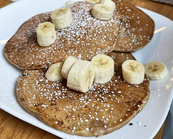 Banana pancakes that make you wonder if Elvis himself would approve—a stack of morning glory topped with fruit and powdered sugar confetti.