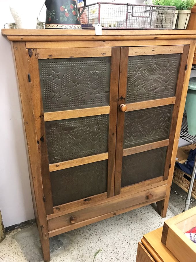A pie safe that's survived longer than most marriages, with punched tin panels that whisper tales of freshly baked cobblers cooling on summer afternoons.