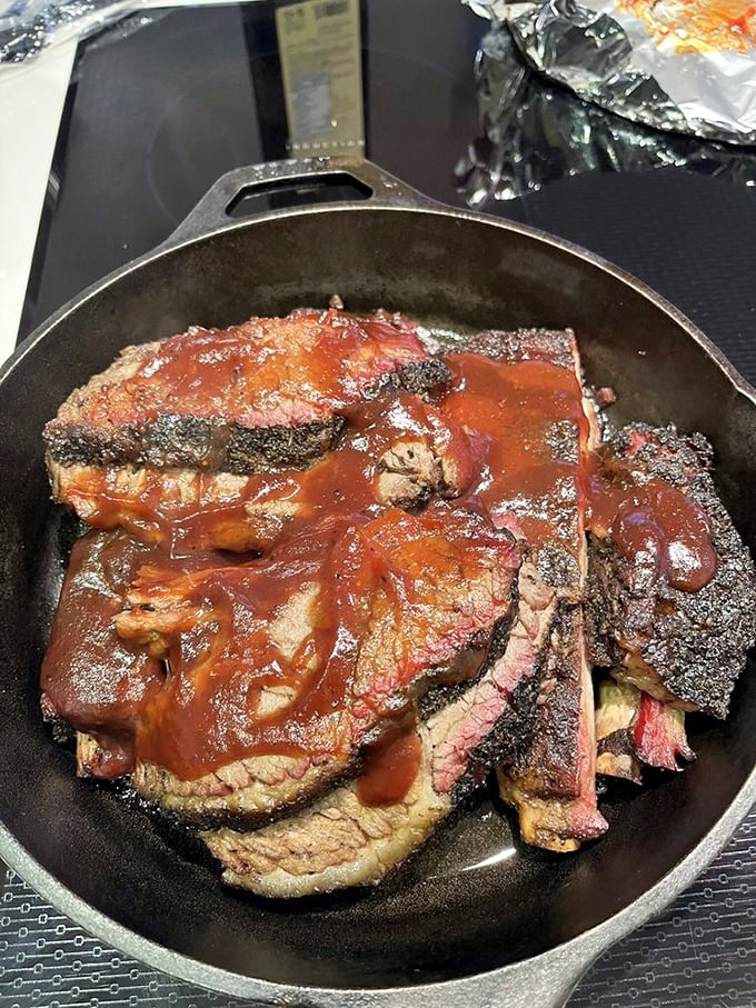 Brisket slices with a smoke ring so perfect it belongs in a barbecue museum. The sauce is just a supporting actor to this meat's star performance.