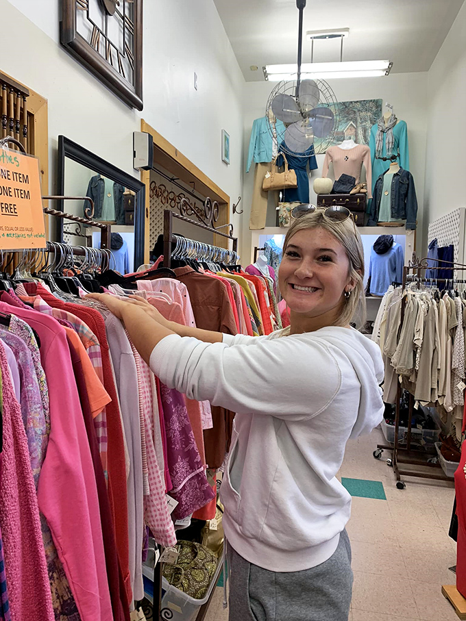 The joy of discovery captured in a single smile – this shopper just found that perfect piece that makes thrifting an addictive treasure hunt.
