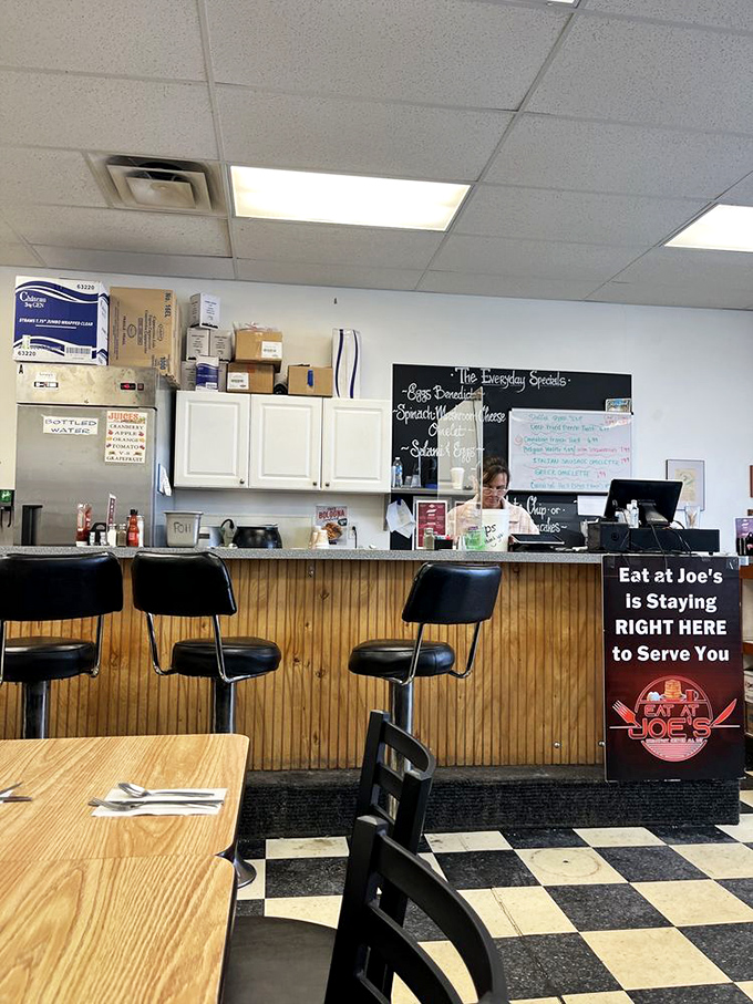 The counter area—where breakfast dreams come to life on a chalkboard and regulars can watch their omelets being born.