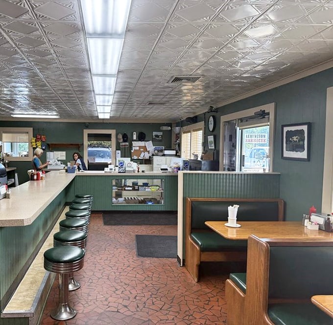 The dining room's green walls and pressed tin ceiling create that perfect time-capsule atmosphere where barbecue traditions are preserved like family heirlooms.