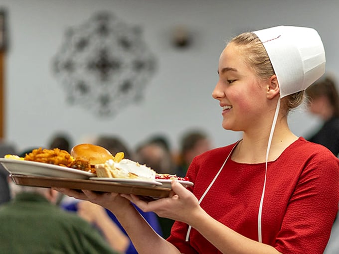 Authentic Amish hospitality served with a smile—traditional attire honors heritage while plates honor your appetite with generous portions.
