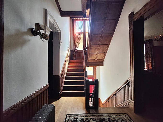 These wooden stairs have witnessed over a century of footsteps, each creak telling a story that would make Stephen King reach for his notepad.