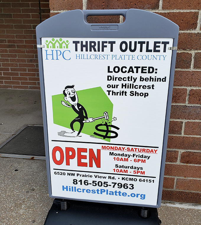 The sidewalk sign reveals the existence of a "Thrift Outlet" behind the main store—like finding a secret level in your favorite video game.
