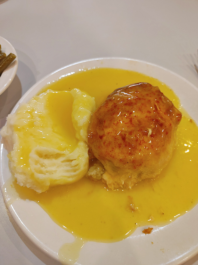 This stuffed chicken breast floating in golden sauce is what comfort food dreams are made of—a sunshine-colored pool of pure happiness.