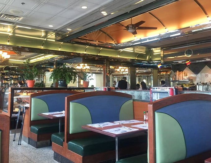 The booths aren't just seating—they're time machines upholstered in teal vinyl, ready to transport you to the golden age of American dining.