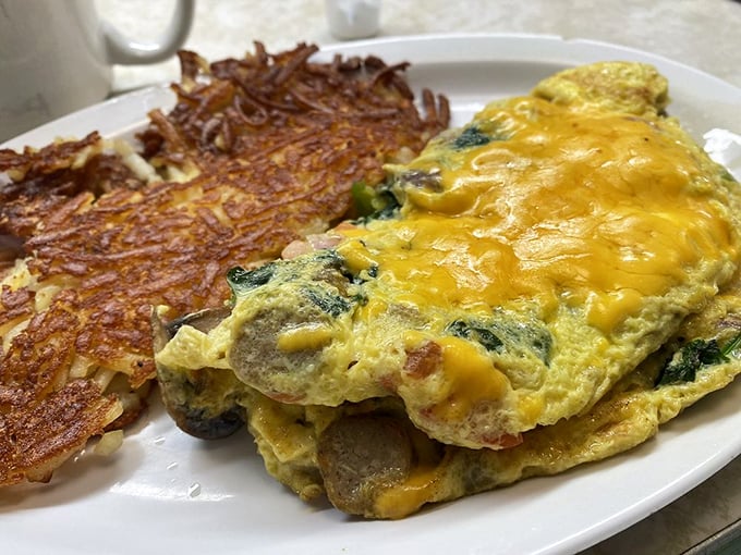 This isn't just any omelet—it's a cheese-blanketed sleeping bag for vegetables that somehow makes eating greens feel rebellious and indulgent.