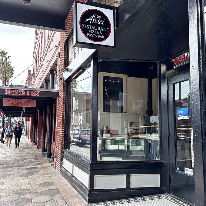 The classic brick façade of Due Amici whispers of pizza traditions passed down through generations. History you can taste.