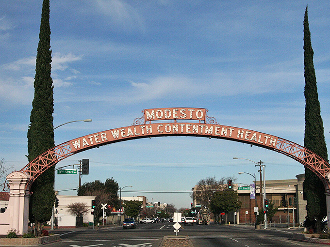 The famous Modesto arch welcomes visitors with promises of "Water, Wealth, Contentment, Health"—and we'd add "affordable retirement" to that list!