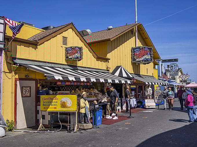 The iconic yellow exterior of Old Fisherman's Grotto stands like a beacon of culinary promise on Monterey's wharf, complete with patriotic bunting that screams "America's seafood lives here!"