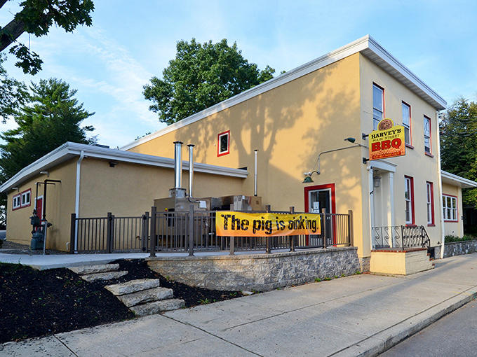 The bright yellow exterior of Harvey's Main Street BBQ announces itself with a banner that doesn't mince words: "The pig is cooking." Consider yourself warned—and enticed.