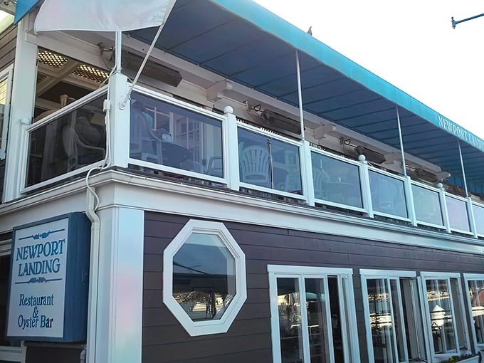 Newport Landing's distinctive octagonal windows and navy blue awnings stand as a maritime beacon for hungry travelers navigating Newport Beach's dining scene.