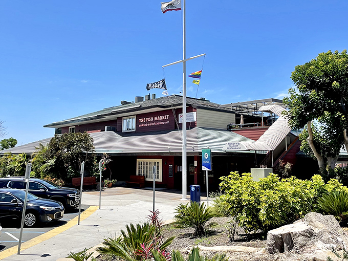 The Fish Market's nautical exterior stands like a welcoming lighthouse for hungry seafood pilgrims. Those flags aren't just for show—they're signaling "fresh catch ahead!"