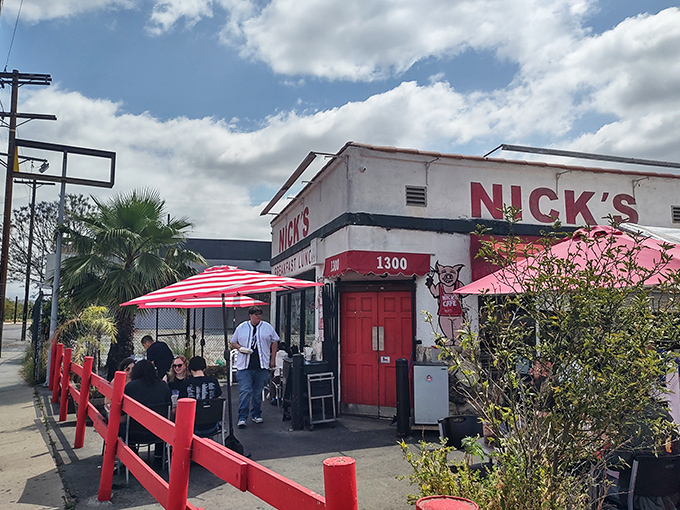 The unassuming white stucco building with bold red "CAFE" lettering stands like a time capsule amid industrial Los Angeles. No fancy facade needed when the food speaks volumes.