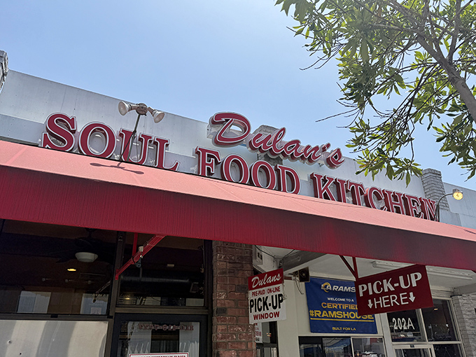 The red awning beckons like a culinary lighthouse on Manchester Boulevard—this is where soul food dreams come true in Inglewood.
