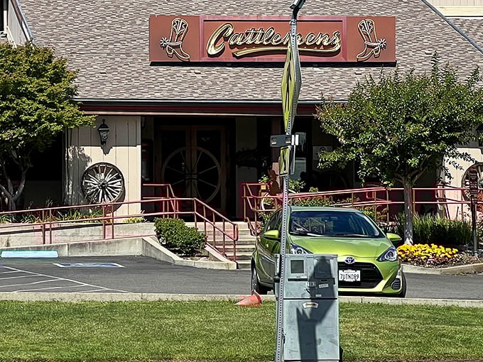 The iconic Cattlemens exterior beckons hungry travelers with its Western charm and cowboy boot signage—a beacon of beef in Redding's landscape.