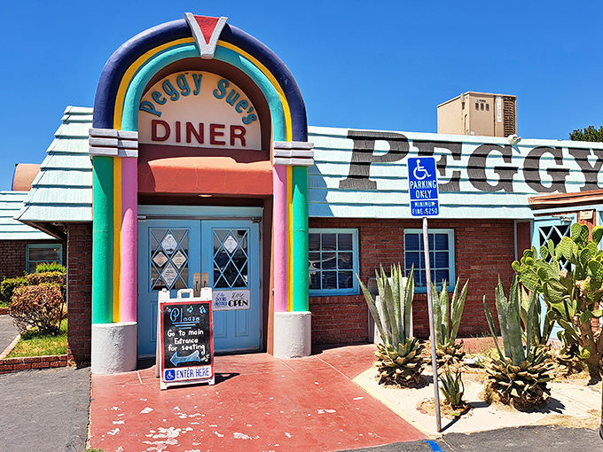 The rainbow-arched entrance to Peggy Sue's stands like a time portal in the Mojave Desert, promising comfort food salvation to weary travelers.