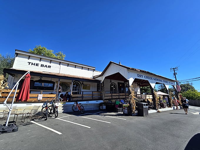 The white clapboard façade of Dry Creek General Store stands like a time capsule in Healdsburg, complete with "THE BAR" sign that promises good times ahead.