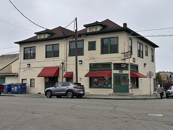 The cream-colored building with distinctive red awnings stands like a time capsule on the corner, beckoning hungry travelers with promises of old-world Italian delights.