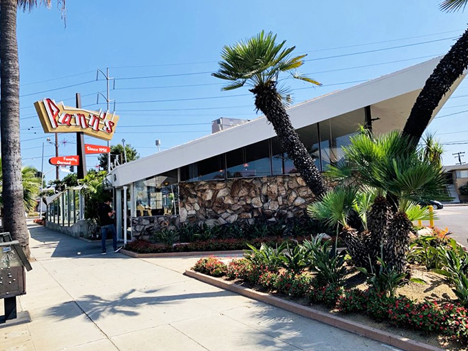That iconic neon sign isn't just calling you to breakfast—it's beckoning you back to an era when diners were social hubs and architectural statements rolled into one delicious package.