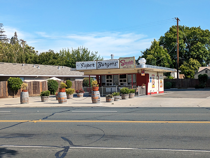 The classic red and white façade of Snow White Drive-In stands like a time capsule in Lodi, beckoning hungry travelers with its "Super Burgers" promise.