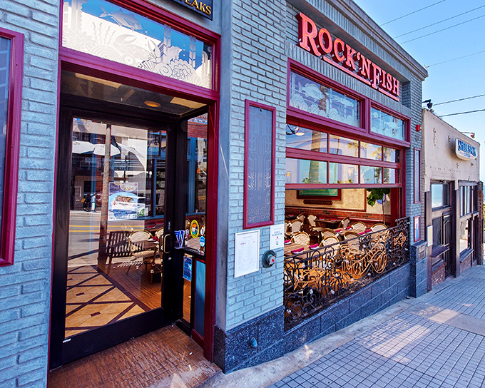 The iconic blue-and-red façade of Rock'n Fish beckons seafood lovers like a maritime lighthouse, promising delicious treasures within just steps from Manhattan Beach Pier.