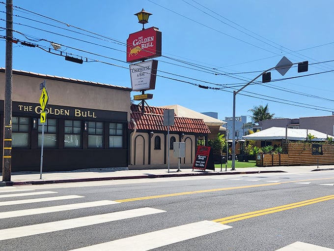 The iconic red sign of The Golden Bull stands as a beacon for hungry souls seeking refuge in Santa Monica Canyon's culinary landscape.