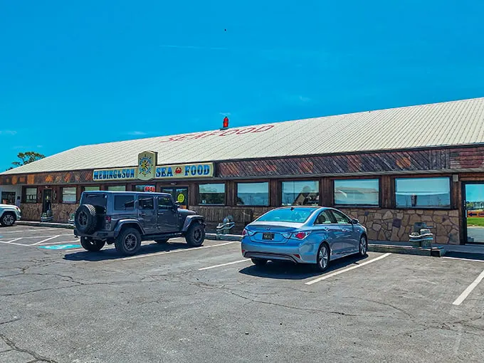The unassuming exterior of Meding's Seafood beckons like a lighthouse for hungry travelers. That blue sign promises seafood salvation just off the highway.