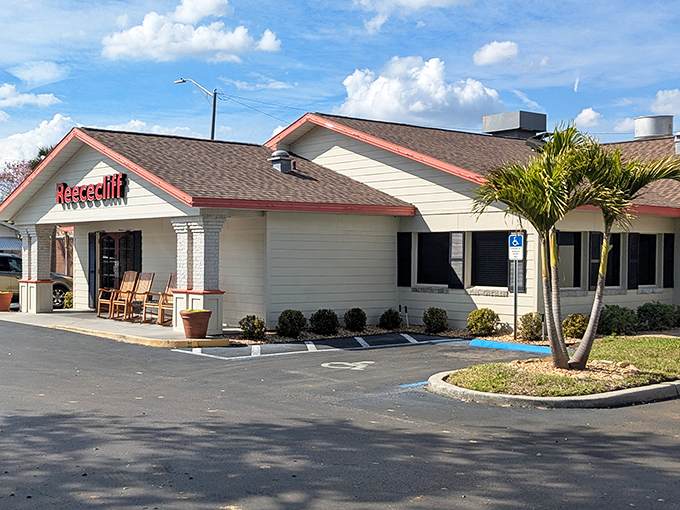 The iconic white exterior with red trim and wooden rocking chairs says "slow down, friend—good food takes time."