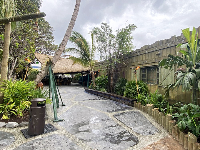 The iconic Mai-Kai sign stands like a neon-lit portal to Polynesia, promising tropical adventures amid lush gardens and cascading waterfalls.
