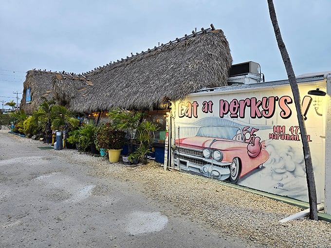 The thatched roof isn't just for show—it's nature's air conditioning in the Florida Keys. Pelicans perch above while that pink pig beckons you inside.