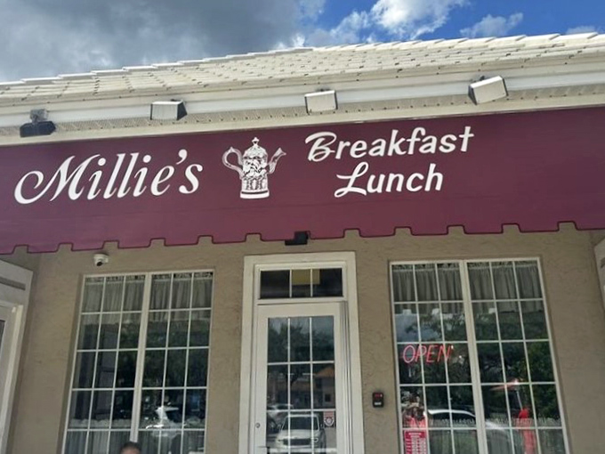 Millie's burgundy awning beckons like a breakfast lighthouse, guiding hungry souls to a harbor of pancakes and possibilities.