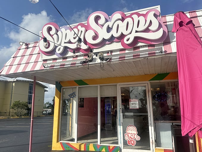 The pink-and-white striped awning of Super Scoops stands out like a beacon of sweetness on Treasure Island, promising frozen salvation from the Florida heat.