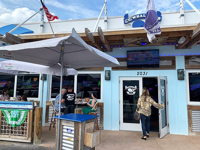 The blue and white striped awning of The Whale's Rib stands out like a maritime flag signaling "great seafood ahead" on Deerfield Beach's coastline.
