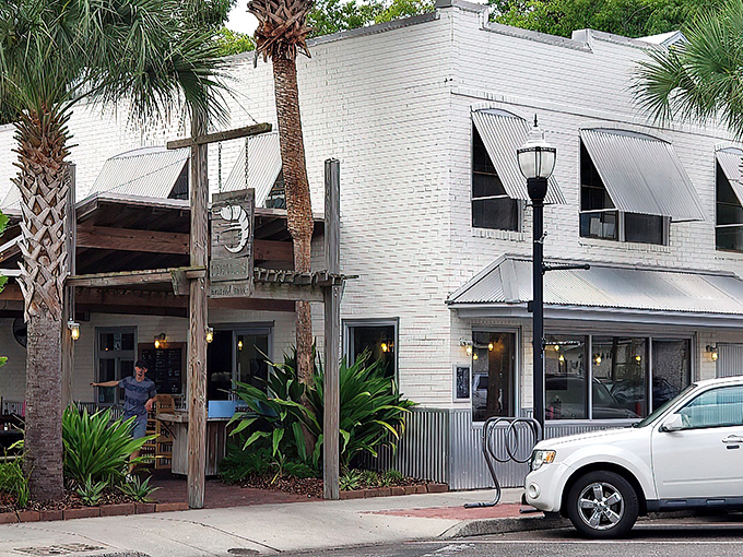 The unassuming white brick exterior of Timoti's Seafood Shak stands like a culinary lighthouse among Fernandina Beach's palm trees, promising seafood salvation to those in the know.