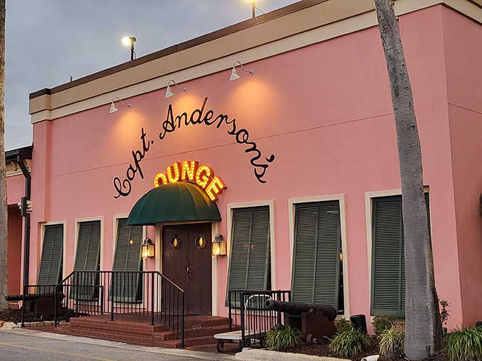 The iconic coral-pink exterior of Captain Anderson's stands like a delicious mirage against the Panama City Beach sky, beckoning seafood lovers from miles around.