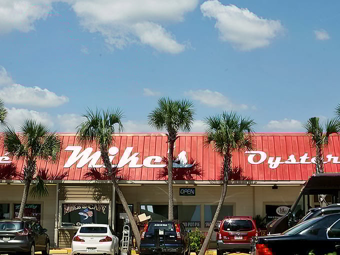 The iconic red roof and palm trees of Mike's Cafe and Oyster Bar stand like a culinary lighthouse, beckoning seafood lovers from across the Panhandle.