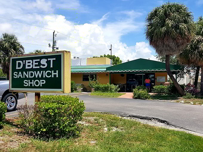 The unassuming yellow building with its green awning and sign might not look like a culinary destination, but locals know better—sandwich paradise awaits inside.