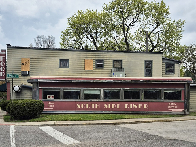 The iconic red exterior of South Side Soda Shop stands like a time capsule on Goshen's Main Street, complete with blue umbrellas inviting you to linger on sunny afternoons.