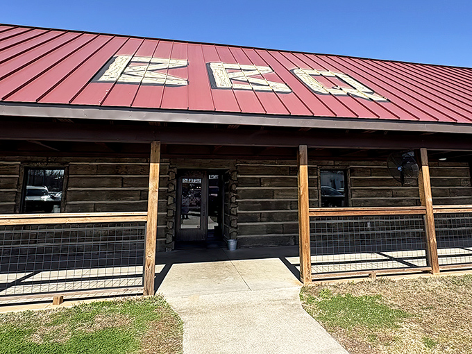 The rustic log cabin exterior with its signature red roof isn't trying to impress anyone—until you taste what's happening inside.