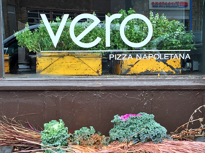 The golden lettering of Vero Bistro beckons like a whisper of Naples against the dark façade, promising authentic Italian delights within.