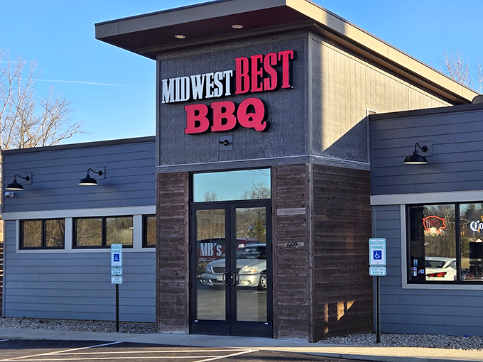 The bold red letters against dark siding announce what awaits inside: barbecue worth crossing county lines for. No fancy frills needed.