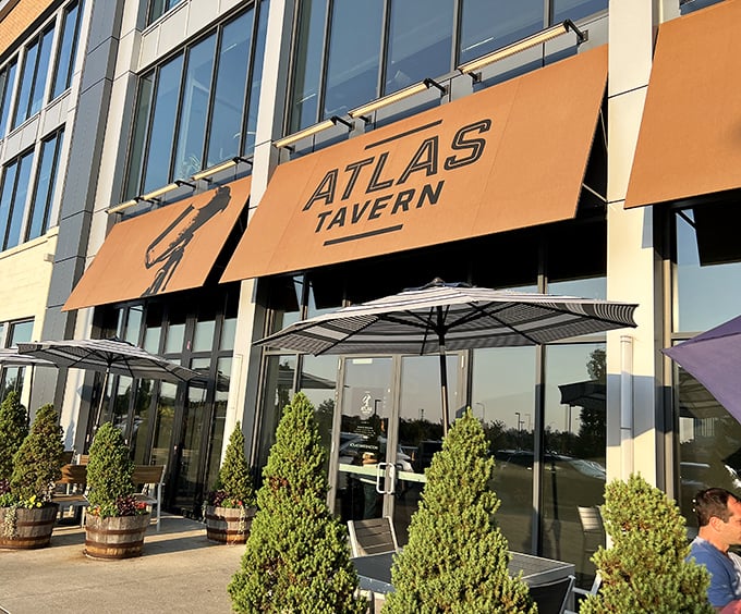 Atlas Tavern's distinctive yellow awnings beckon hungry travelers like a lighthouse guiding ships to harbor. Modern meets comfortable in this Columbus hotspot. 