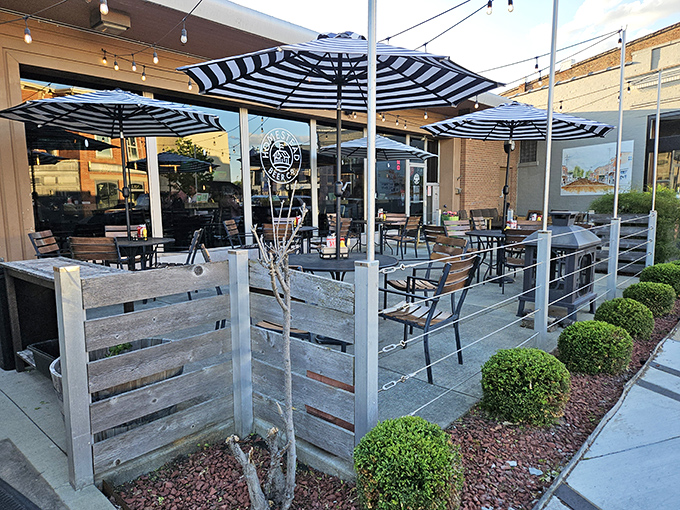 The patio at Homestead beckons with its striped umbrellas and string lights—a perfect spot for summer evenings when Ohio decides to behave weather-wise.