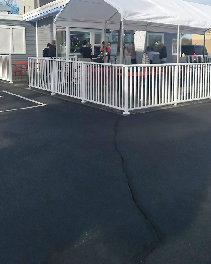 The white picket fence isn't just for show—it's containing pure happiness in the form of ice cream and comfort food at Miller's Drive-In.