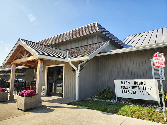 The charming white exterior of The Barn Restaurant's gift shop welcomes visitors with brick pathways and colorful flower beds—a prelude to the comfort food paradise within.