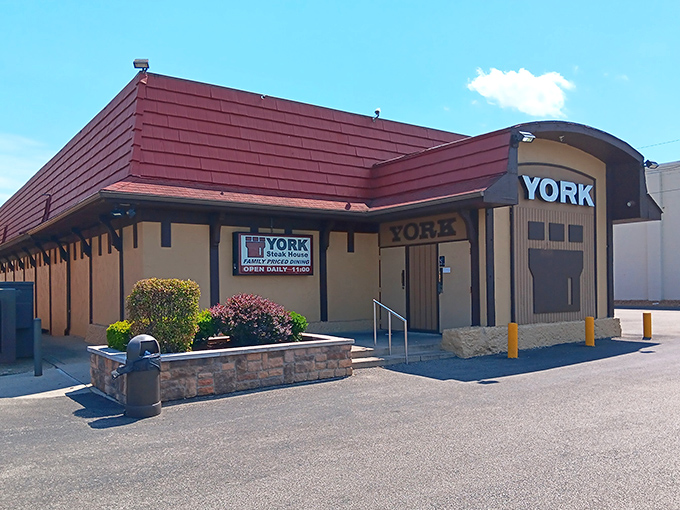 The iconic burgundy roof and beige exterior of York Steak House stands as a time capsule of American dining history, promising "Family Priced Dining" that delivers on both nostalgia and flavor.