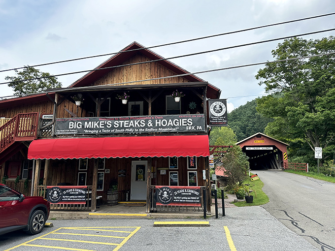 Rustic charm meets culinary legend at Big Mike's, where that red awning and wooden exterior signal you've found Pennsylvania's hidden cheesesteak paradise.